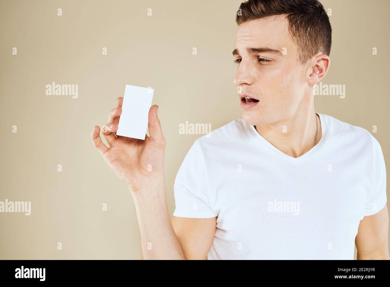 Man with a business card in the hands of an office manager beige ...