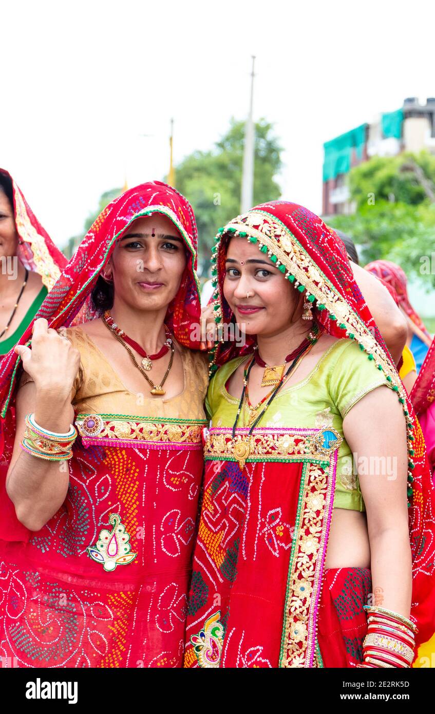 Portrait of Rajasthani women in traditional red sari and jewelry Holy ...