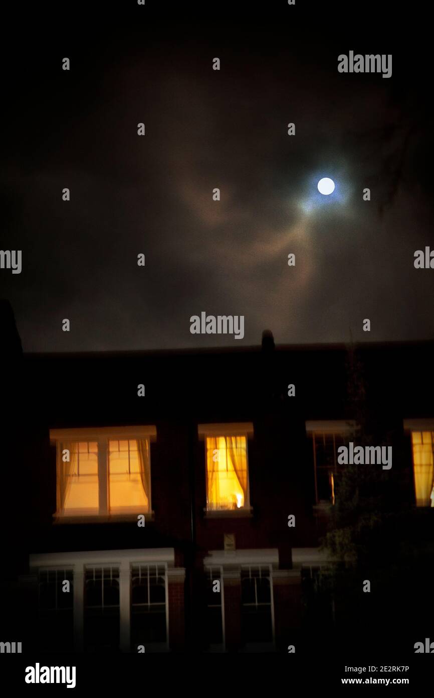 Blurred House Facade with Lights on Under Moonlight Stock Photo - Alamy