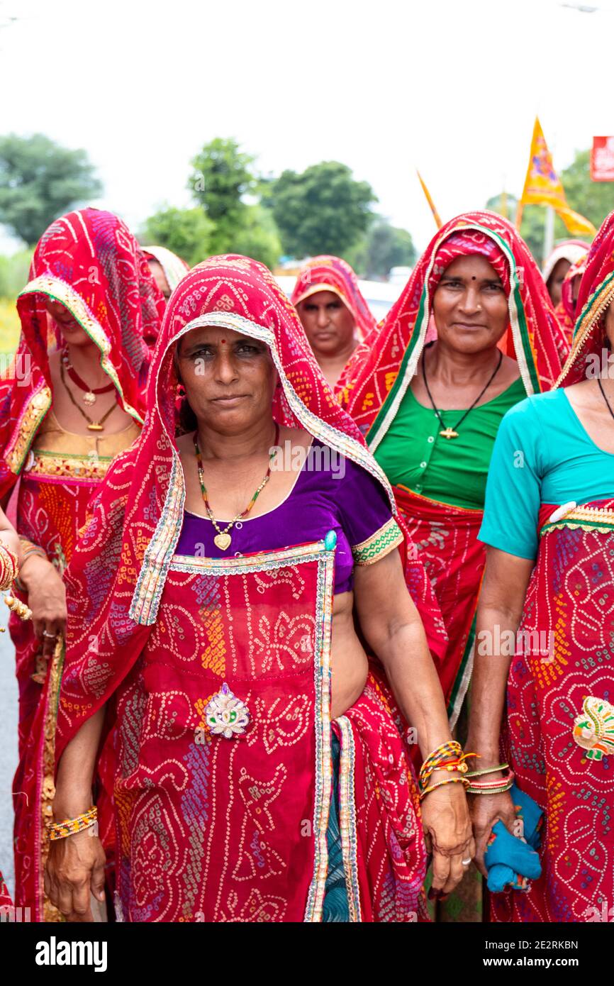 Portrait of Rajasthani women in traditional red sari and jewelry Holy ...
