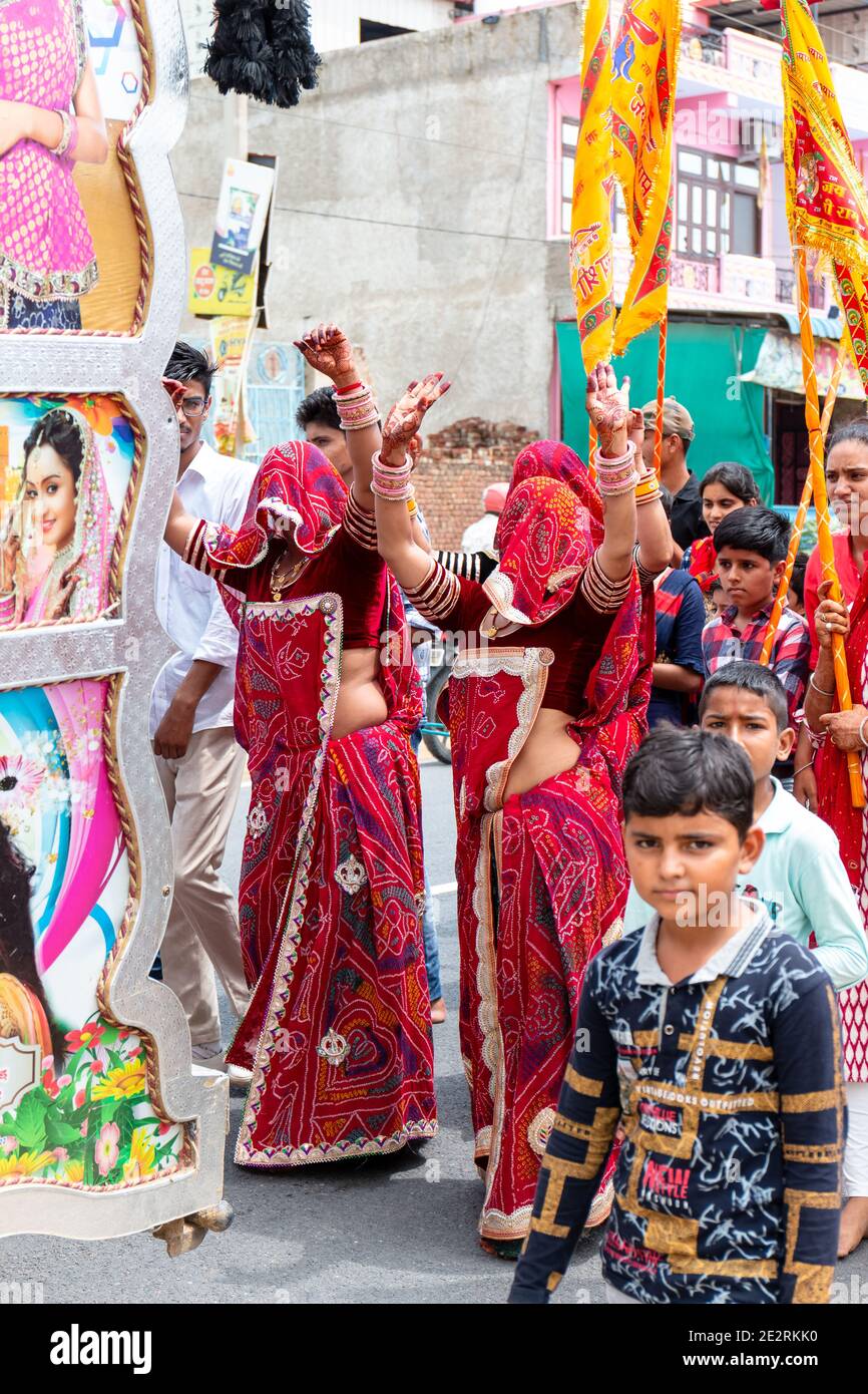 Portrait of Rajasthani women in traditional red sari and jewelry Holy ...