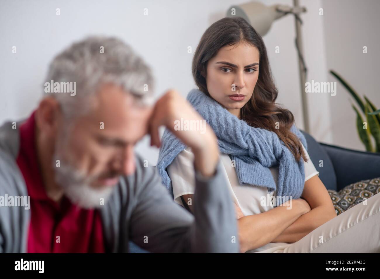 Woman looking angrily on her grey-haired husband Stock Photo - Alamy