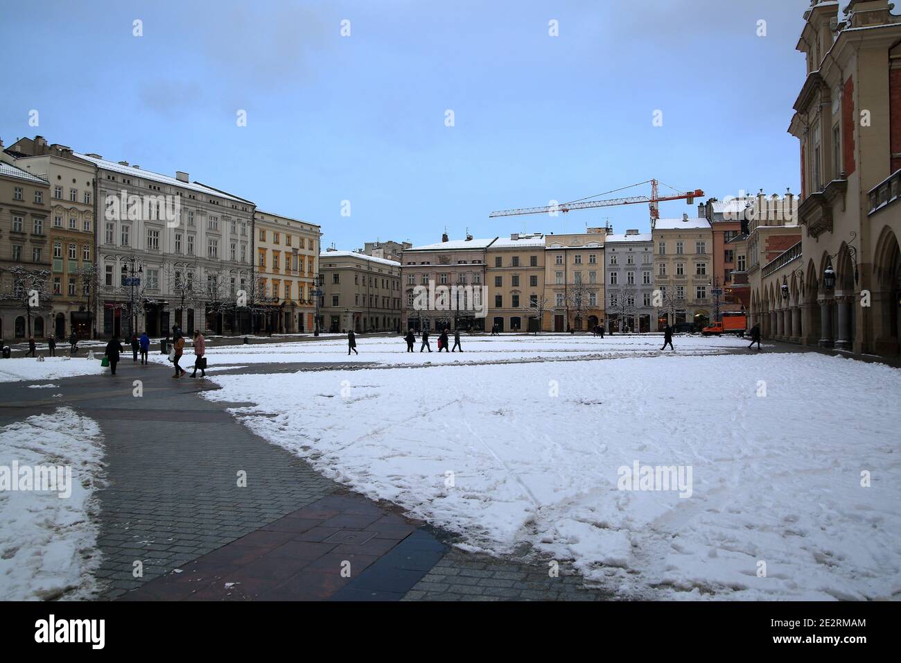 Square in Krakow old town, covered with snow, winter in european city ...