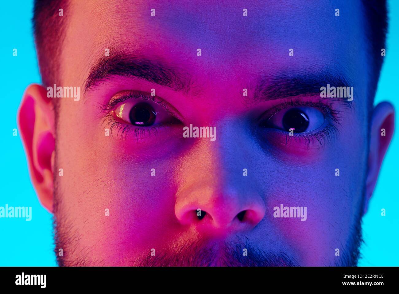 Angry. Caucasian man's portrait isolated on blue studio background in ...