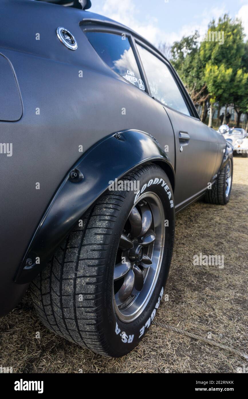Close up detail of the rear wheel and arch of a matte black customised ...