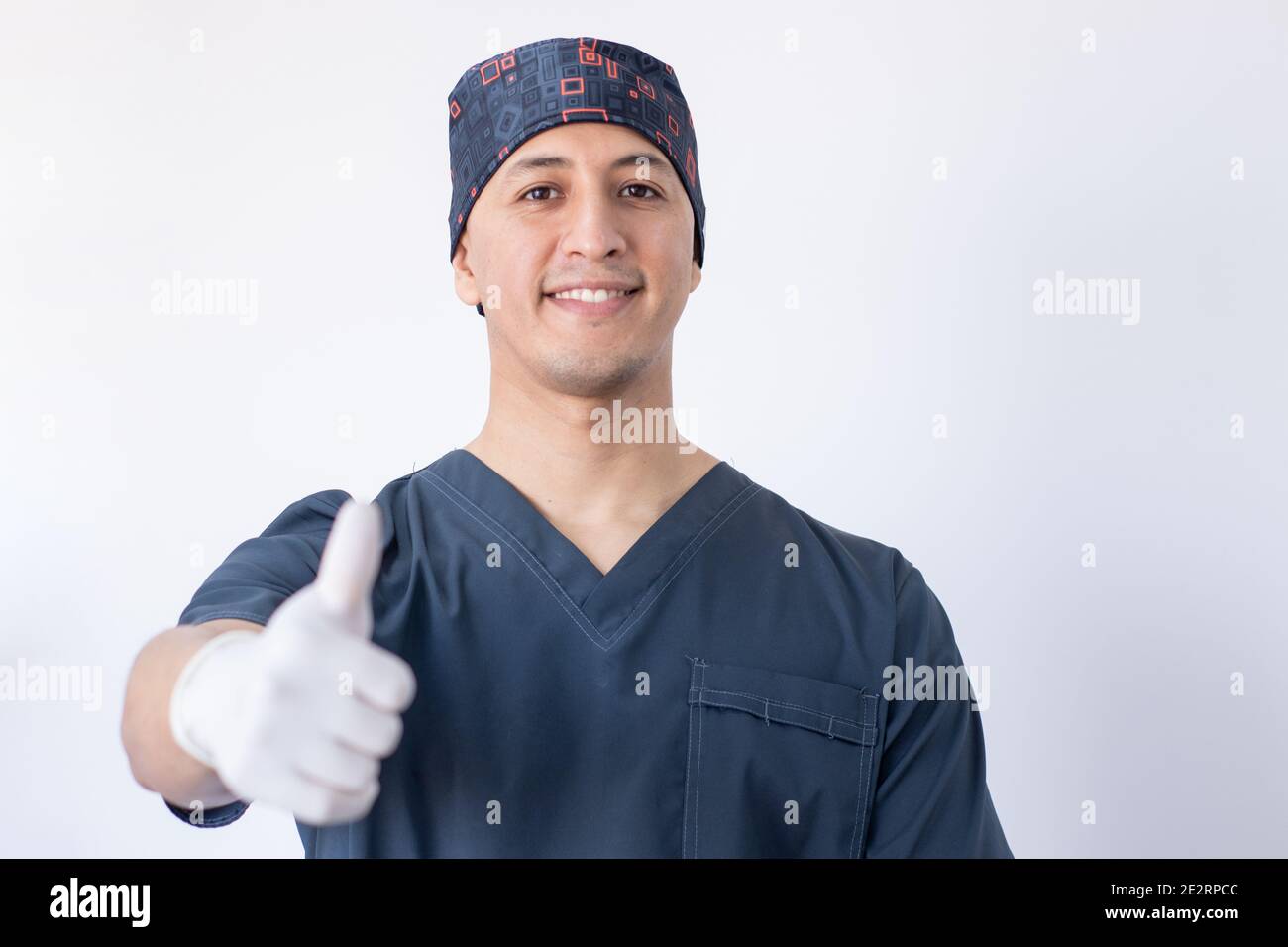Portrait of a Hispanic dentist doing thumbs up Stock Photo - Alamy