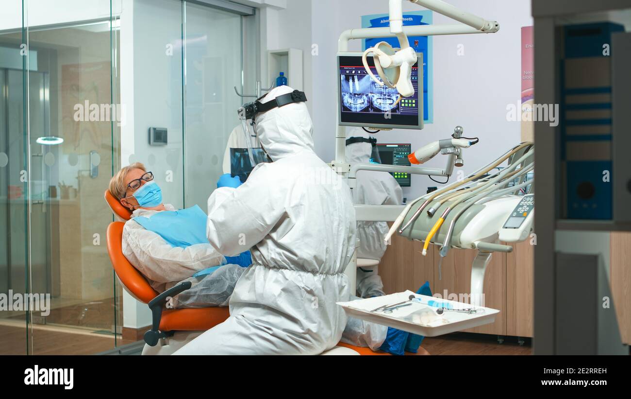 Stomatologist in protective suit asking for patient dental x-ray ...