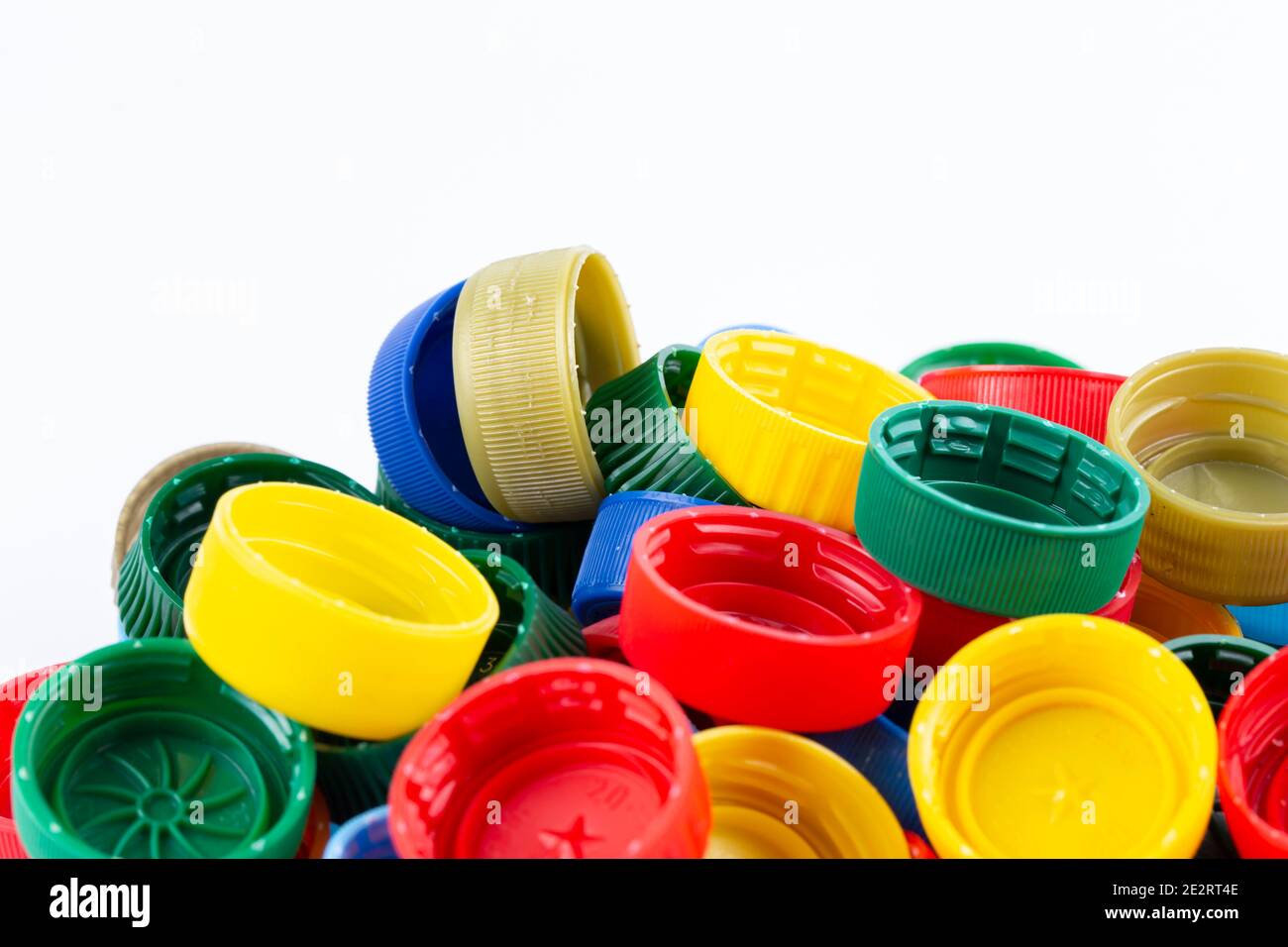 Group of multi colored bottle caps on white background Stock Photo - Alamy