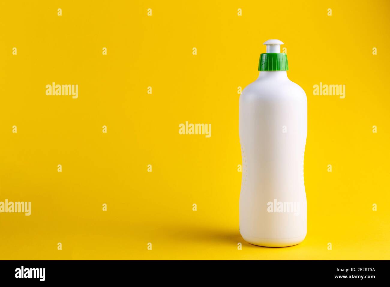 White bottle of cleaning agent on a yellow background. Cleanliness ...