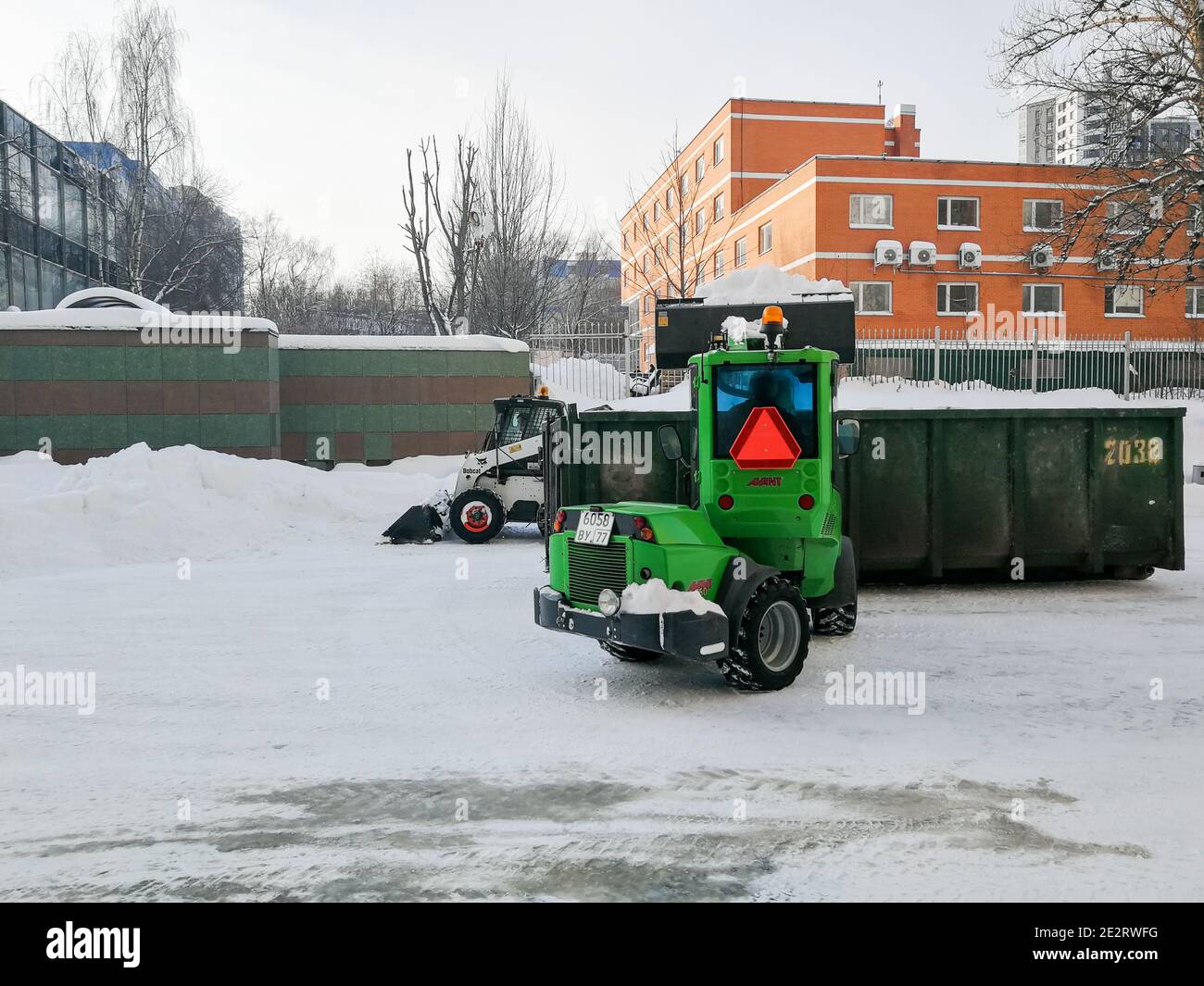 Moscow. Russia. January 15, 2021. Small front-end loaders clear snow ...