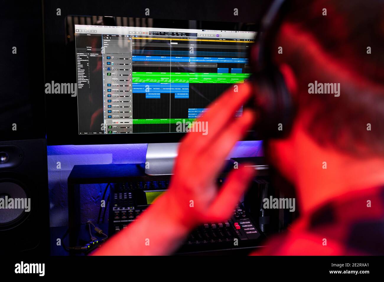 White young DJ is recording a new track in the stereo studio workplace ...