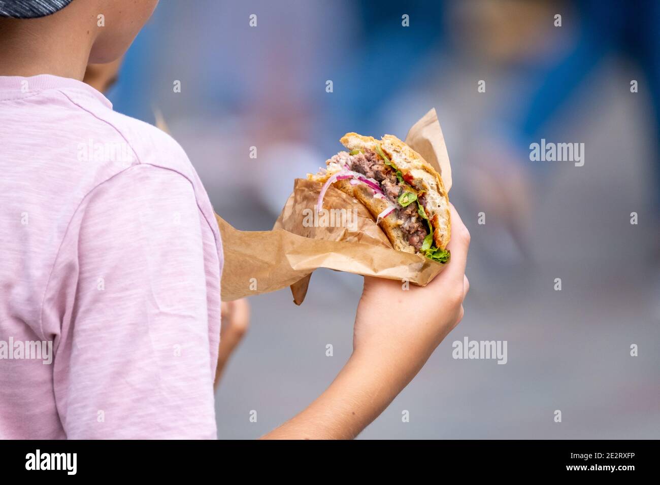 Anonymous child with delicious burger Stock Photo - Alamy