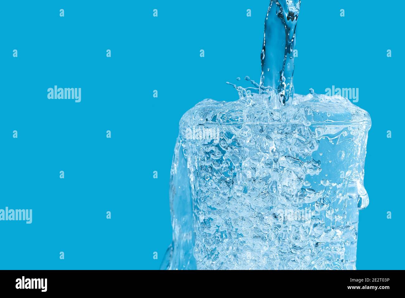 Pouring clean drinking water from blue plastic bottle into glass on ...