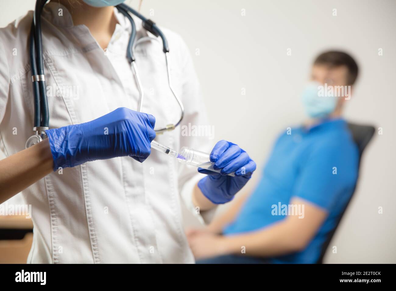 Doctor giving patient needle hi-res stock photography and images - Alamy