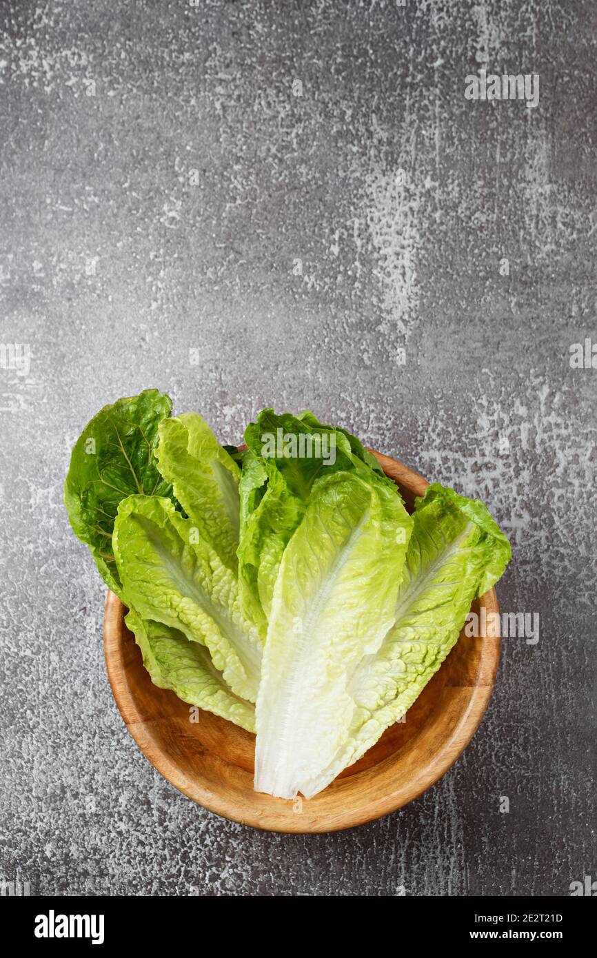 Fresh washed green salad in wooden bowl ready for cooking. Ingredients ...