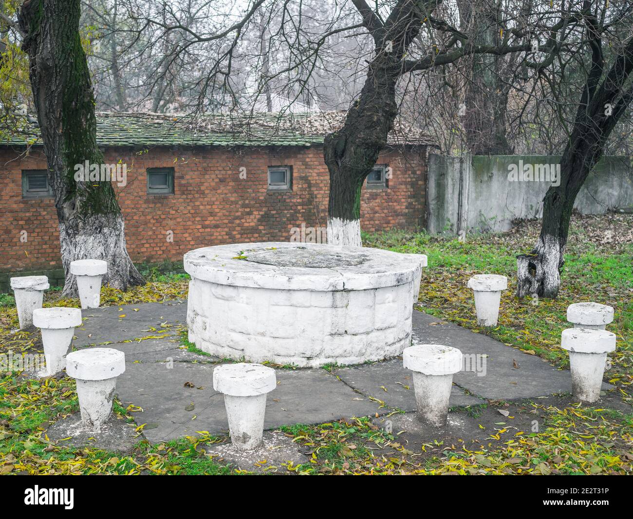 Outdoor ancient medieval stone round table with small stone made chairs ...