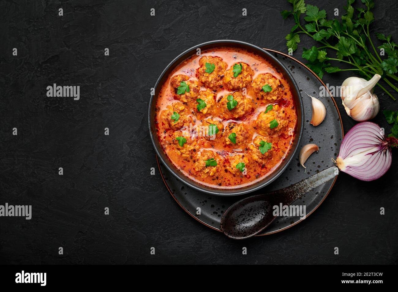 Sulu Kofte in black bowl on dark slate table top. Turkish cuisine soup ...