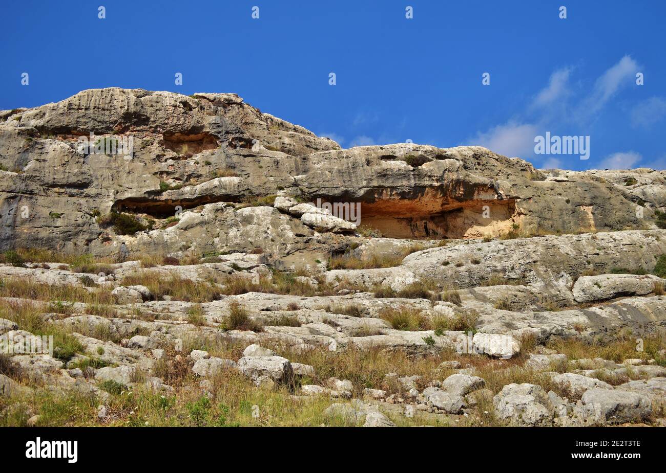 Small cave in the cliff face and karst landscape of Bassasa Valley in ...