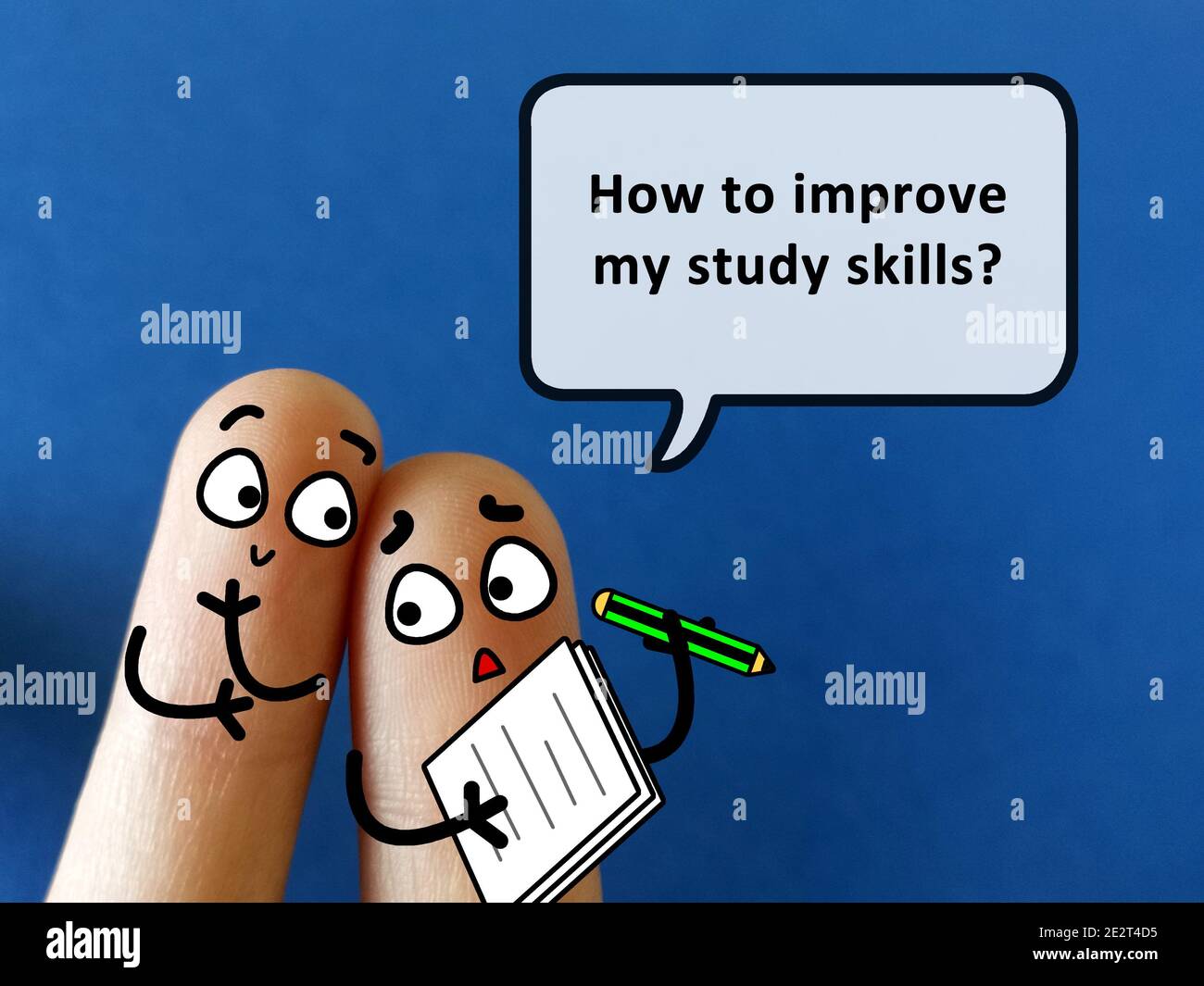 Two fingers are decorated as two students. They are preparing for exam ...