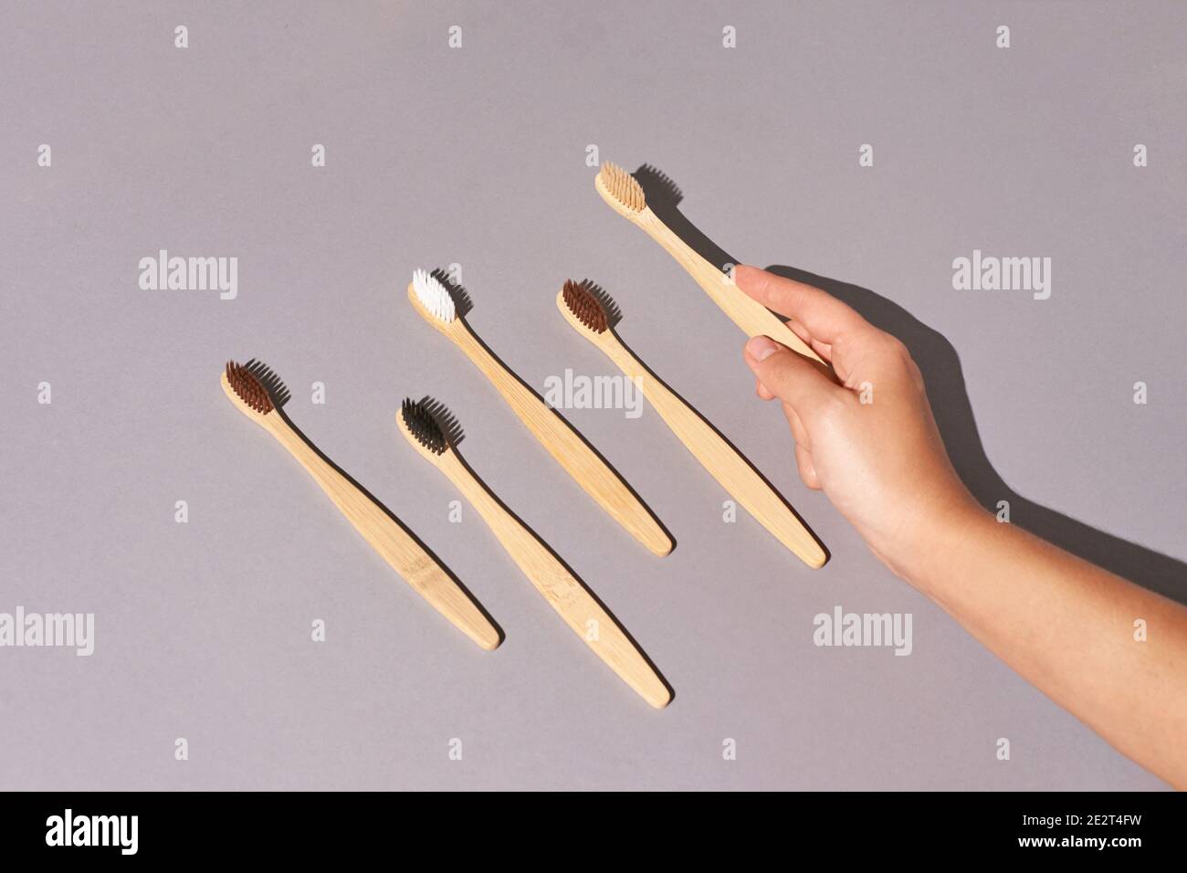 Hand holding toothbrush. Bamboo eco brush Stock Photo - Alamy