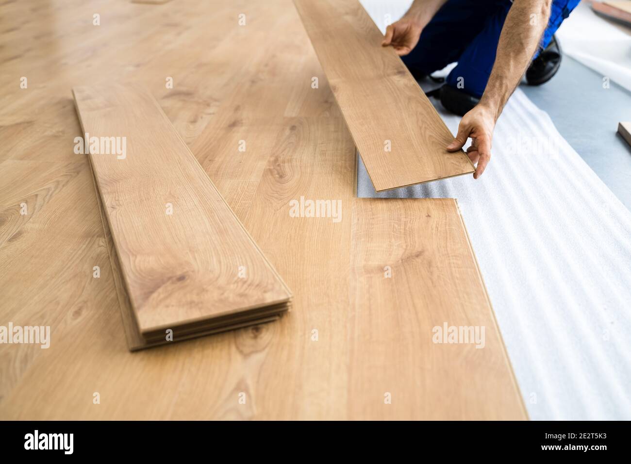 Hardwood Floor Renovation. Construction Worker Doing New Laminate ...