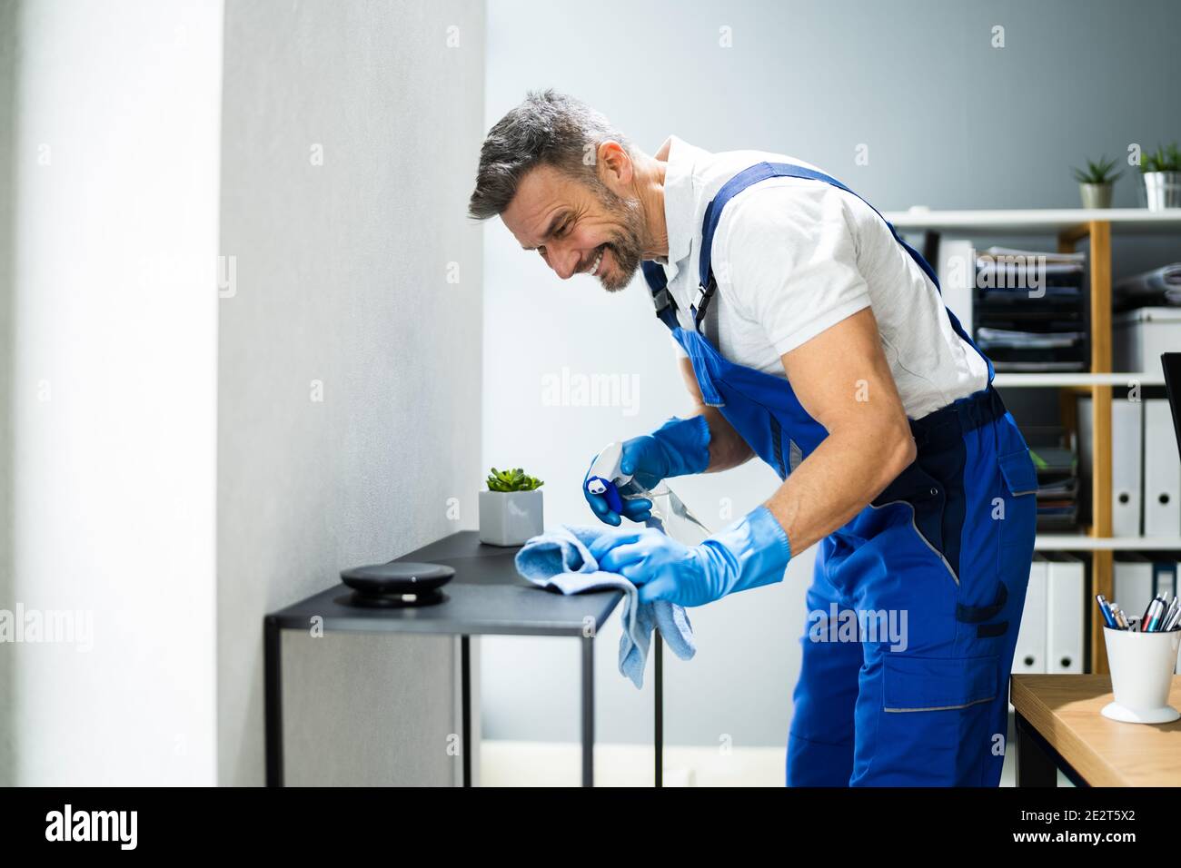 Professional Janitor Office Cleaning Service. Man With Chemical Spray ...