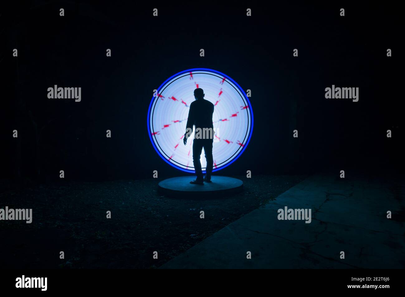 One person standing alone against beautiful color circle LED light ...