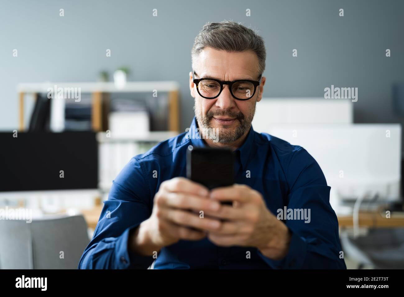 Attractive older man smartphone hi-res stock photography and images - Alamy