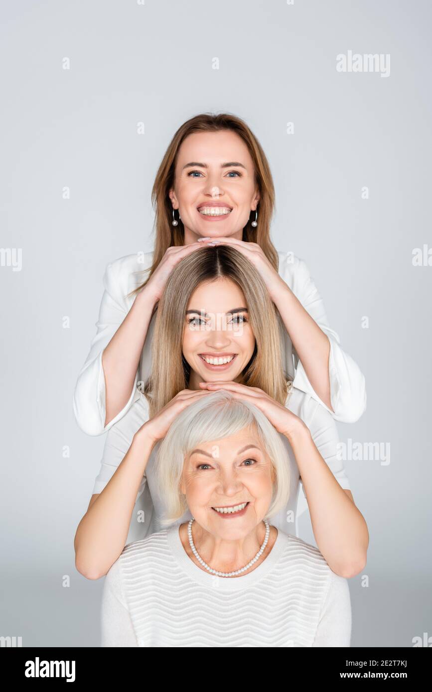 three generation of happy women isolated on grey Stock Photo - Alamy