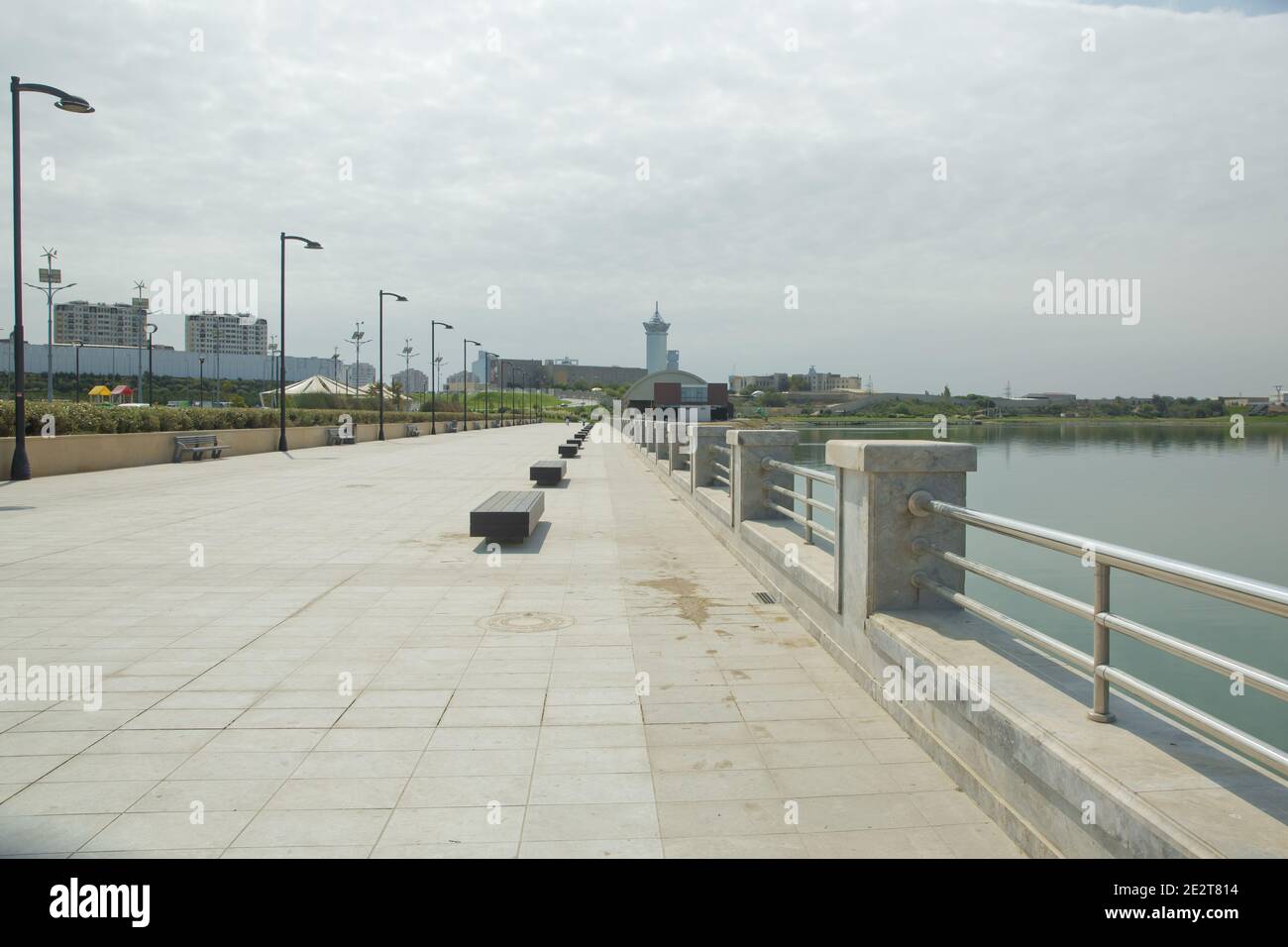 An oval bridge from iron and wood on the edge of the lake . Boyukshor ...
