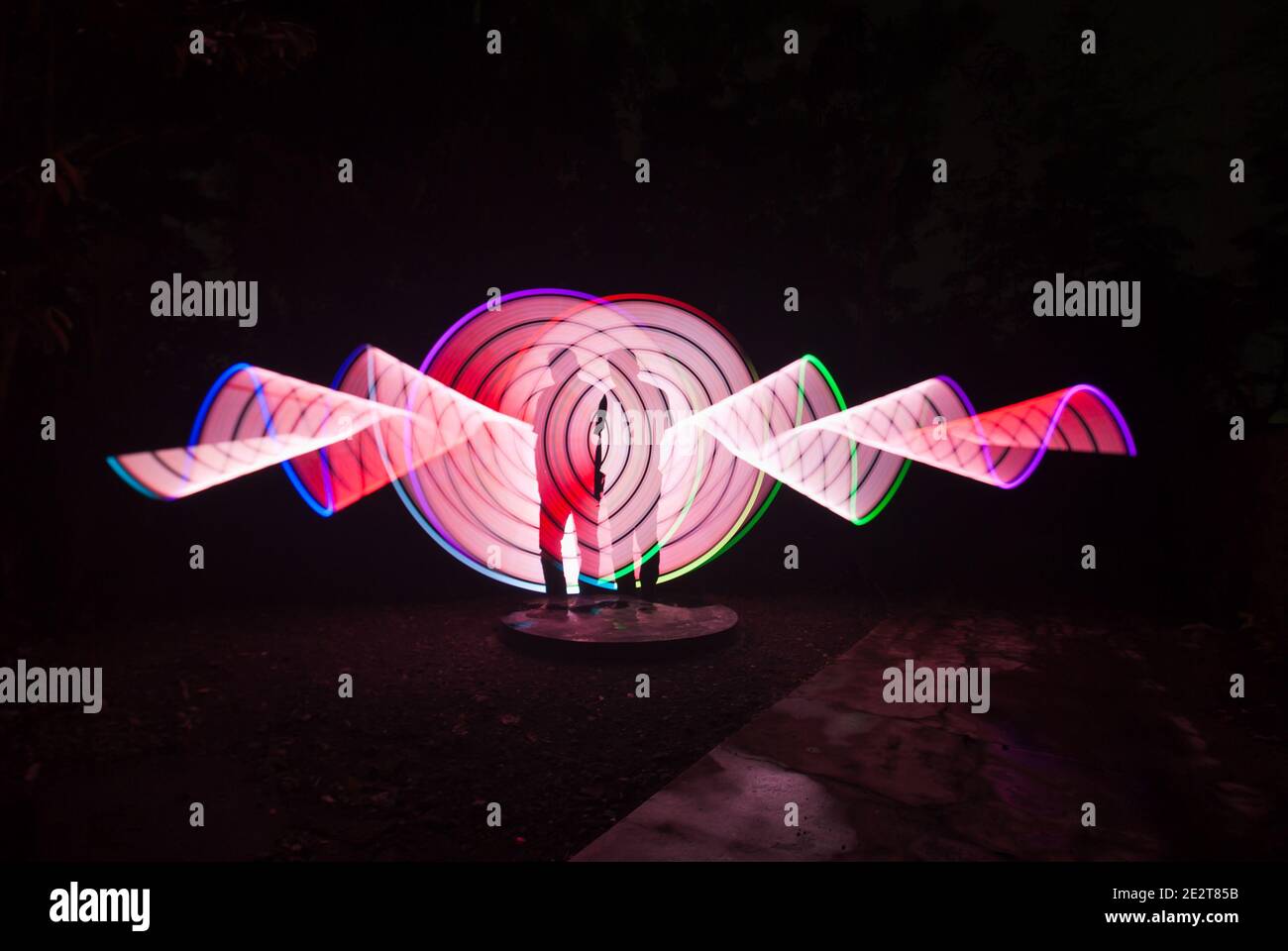Two person standing alone against beautiful color circle LED light ...