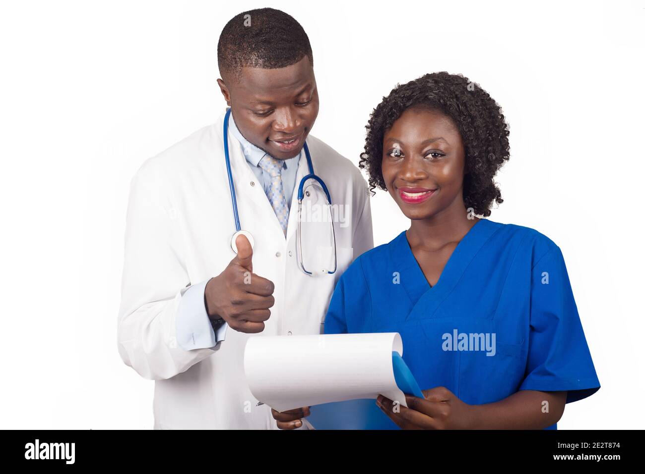 doctor and trainee standing checking medical file of a patient in paper ...
