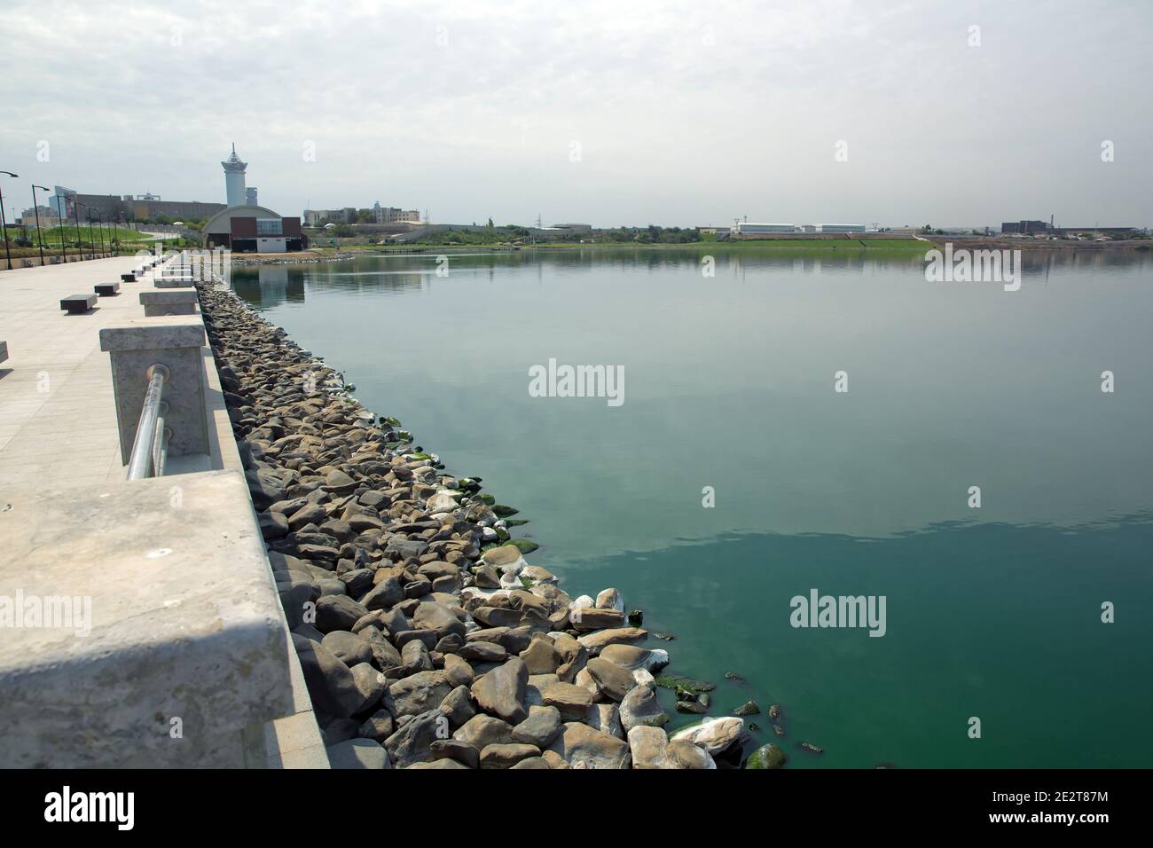 An oval bridge from iron and wood on the edge of the lake . Boyukshor ...