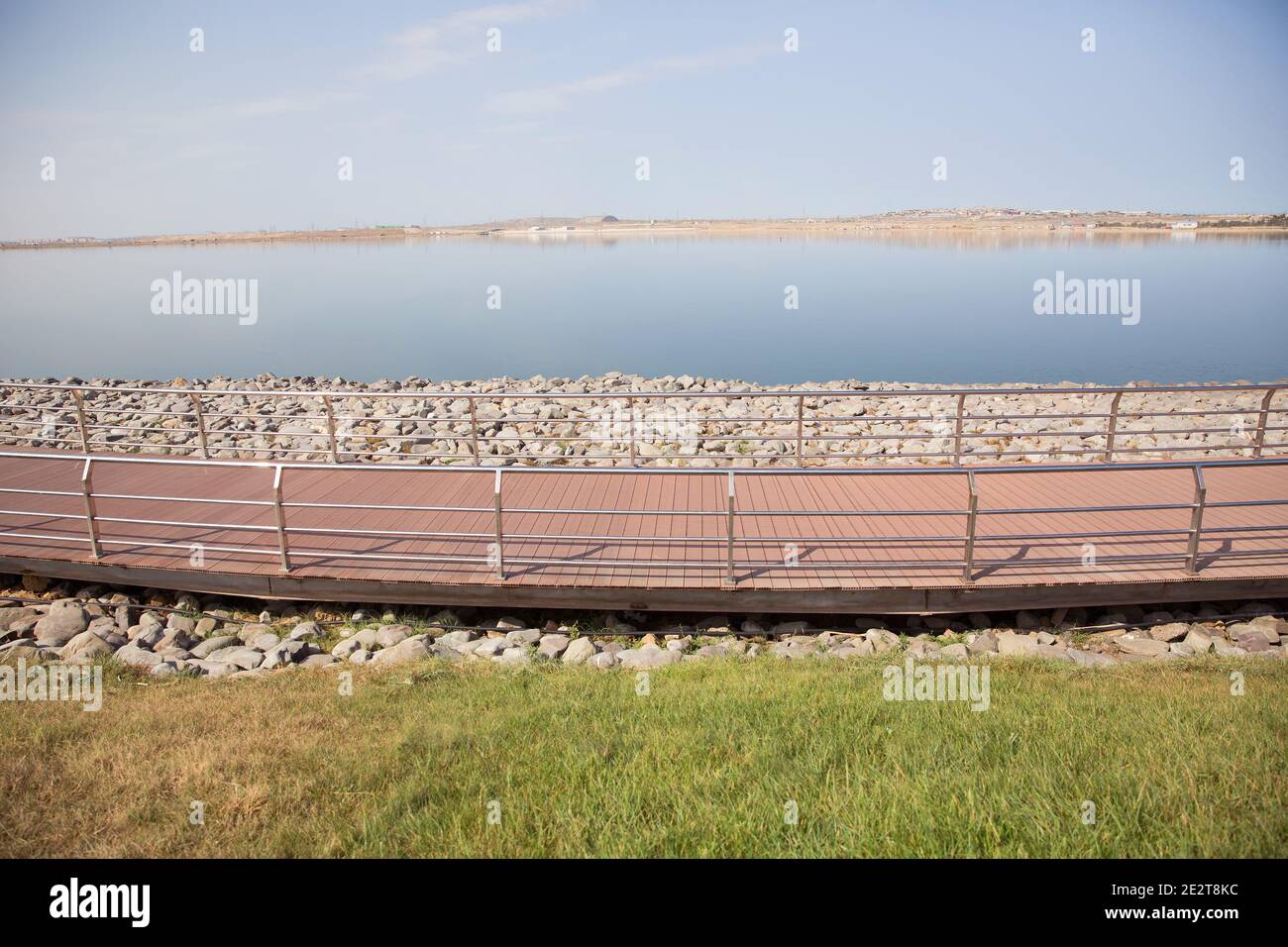 An oval bridge from iron and wood on the edge of the lake . Boyukshor ...