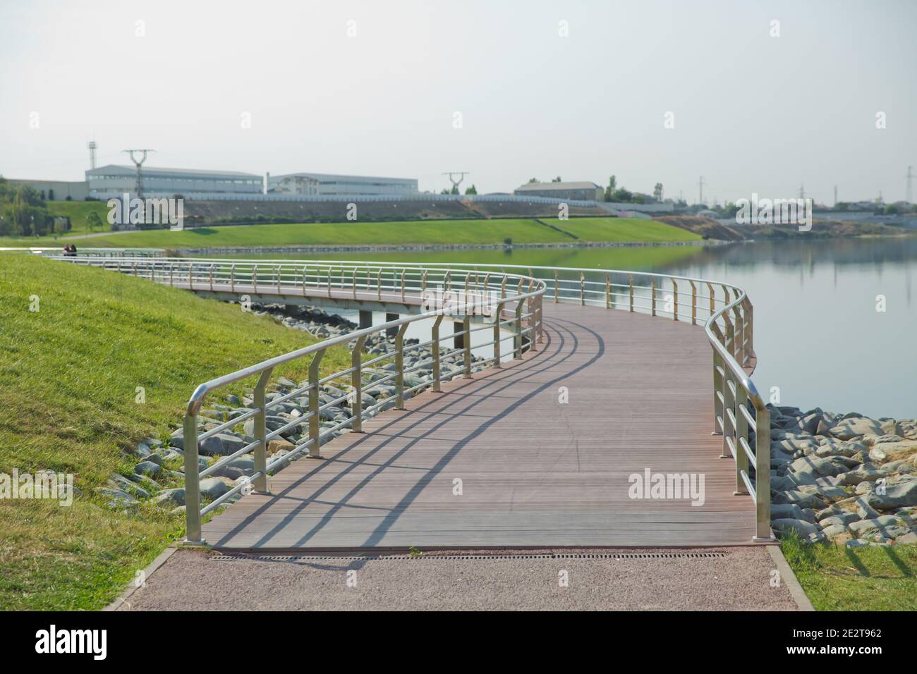 An oval bridge from iron and wood on the edge of the lake . Boyukshor ...