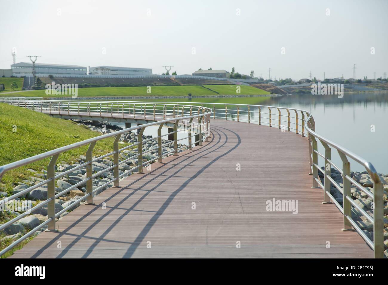 An oval bridge from iron and wood on the edge of the lake . Boyukshor ...