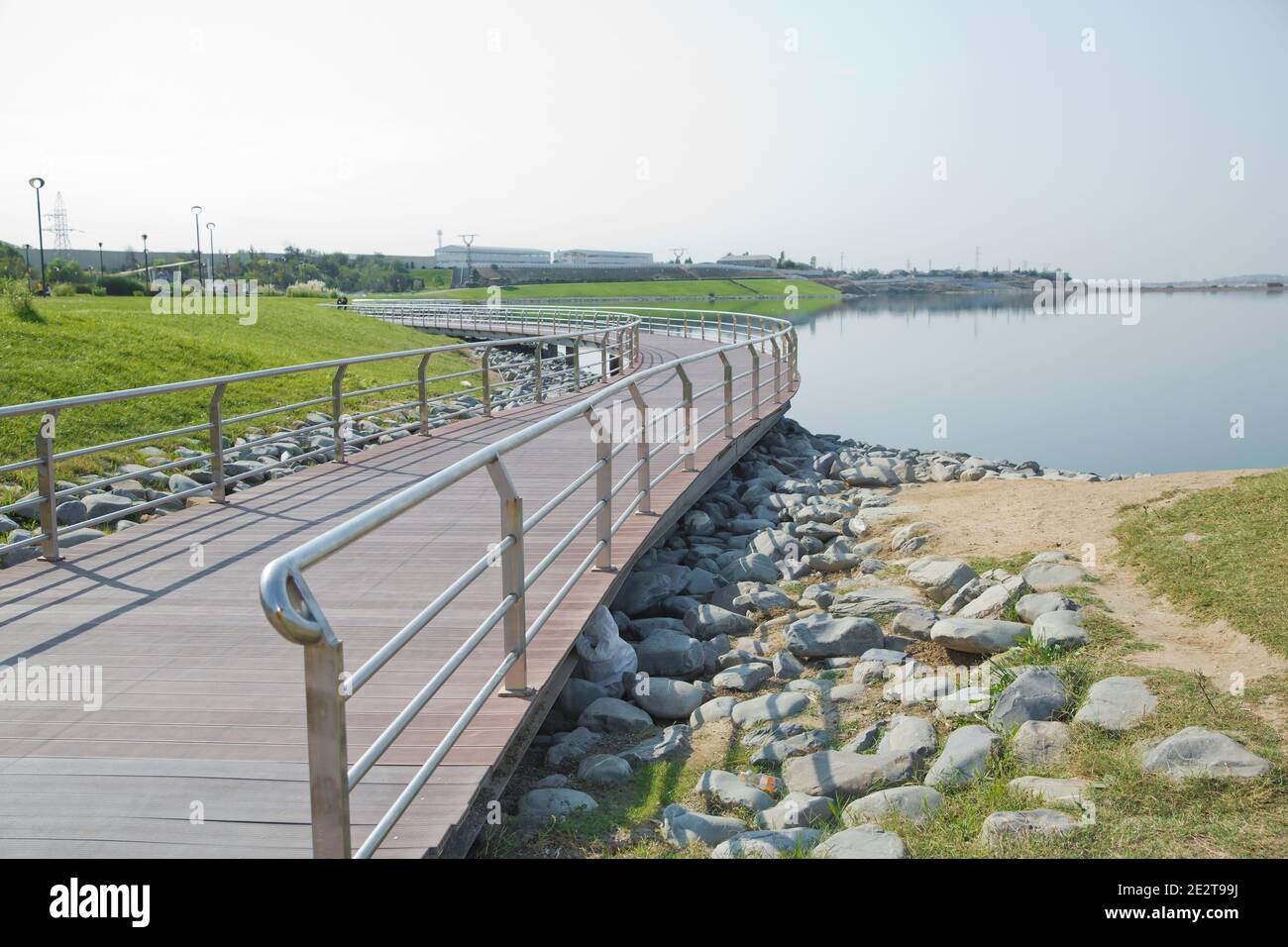 An oval bridge from iron and wood on the edge of the lake . Boyukshor ...