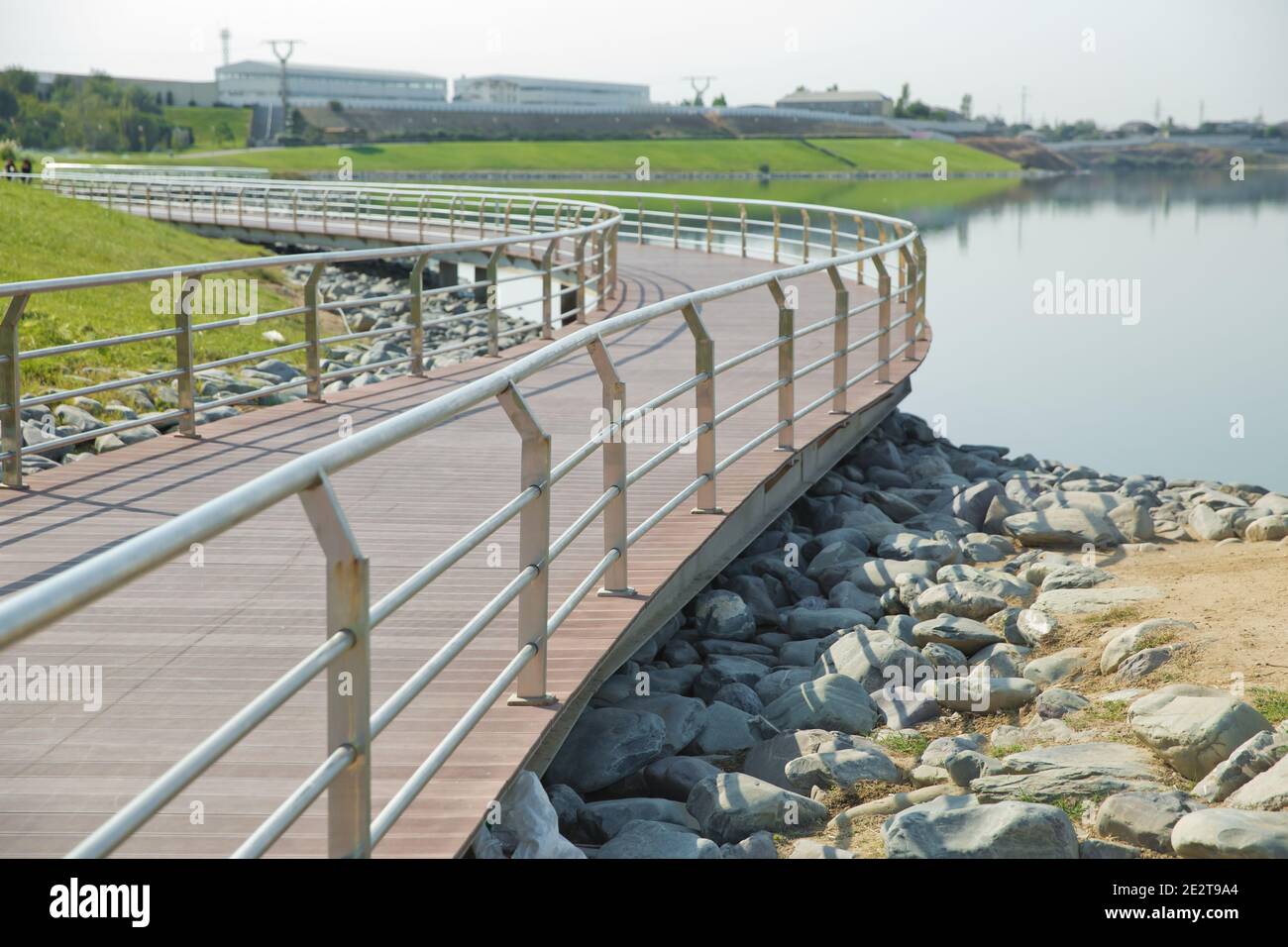 An oval bridge from iron and wood on the edge of the lake . Boyukshor ...