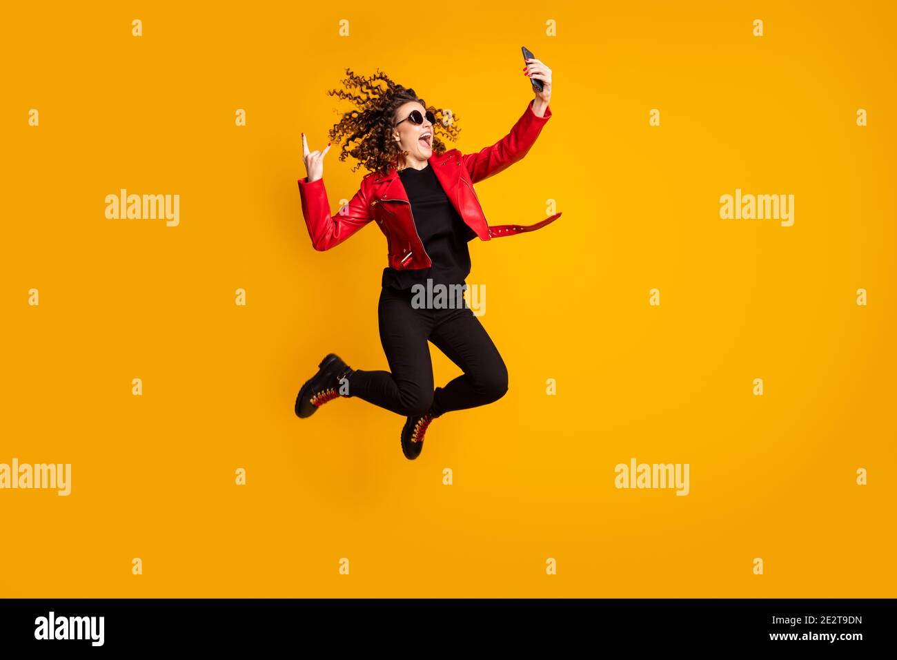 Full length body size view of cheerful wavy-haired girl jumping using ...