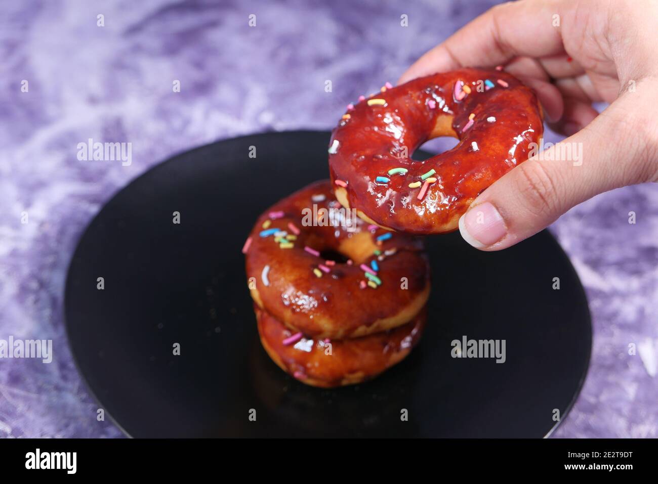 Holding up donuts hi-res stock photography and images - Alamy