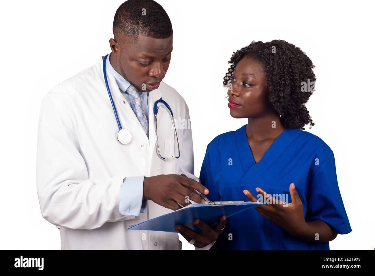 young trainee standing in uniform looking at doctor show him work Stock ...