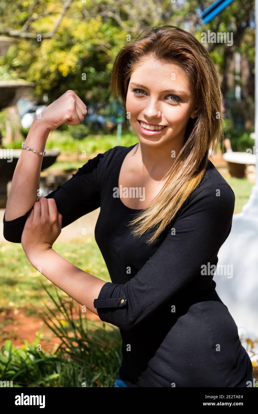 Portrait women flexing biceps in hi-res stock photography and images ...