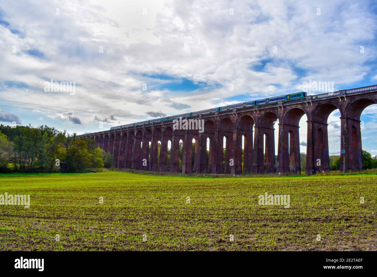 Train on a railway bridge in the UK countryside Stock Photo - Alamy
