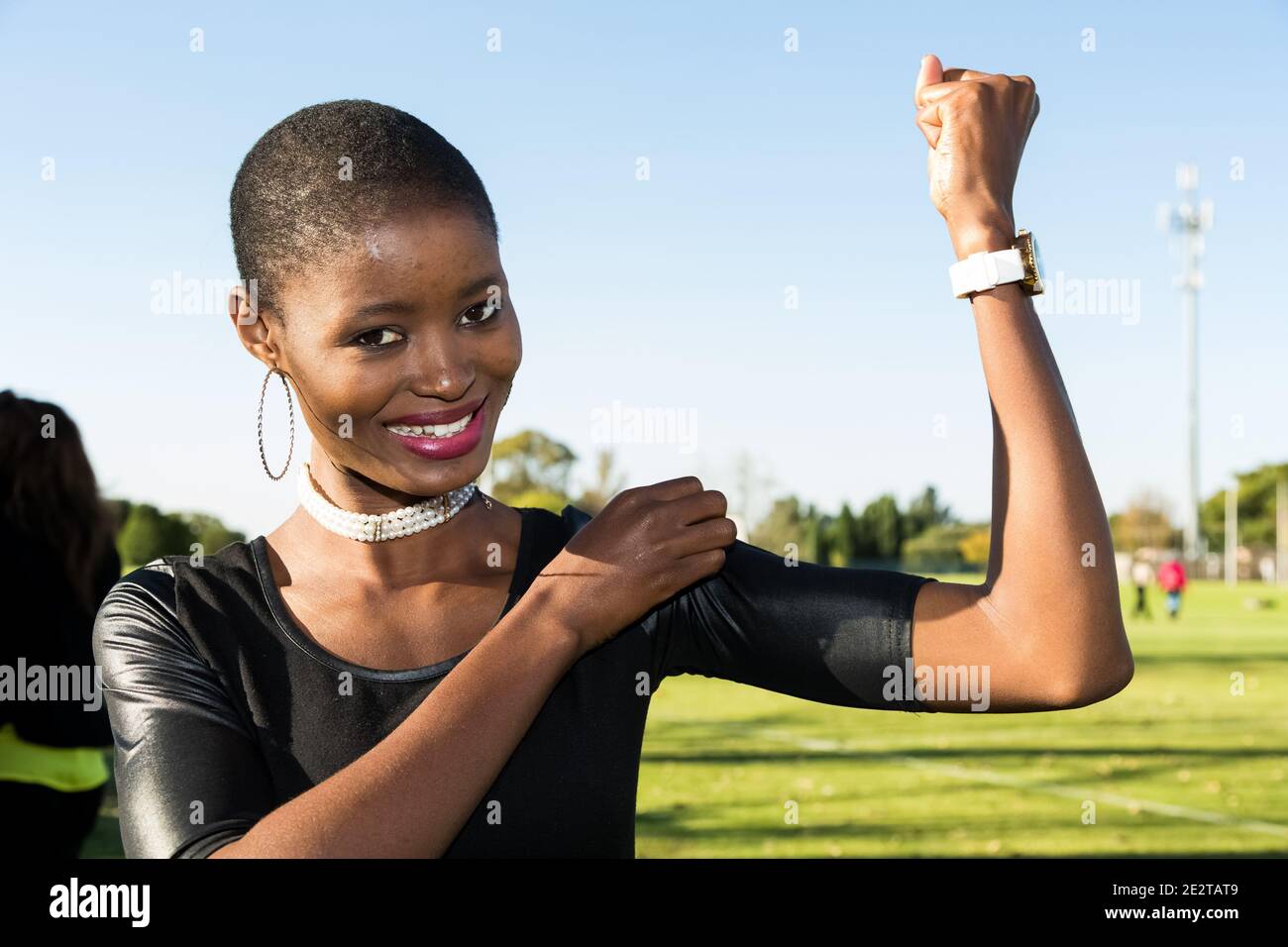 Johannesburg, South Africa - April 30, 2015: Young African girl flexing ...