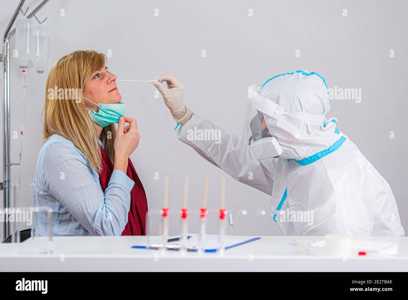 Medical worker performing COVID-19 test, taking nasal swab sample from ...