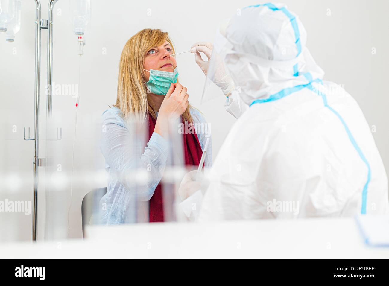 Medical worker performing COVID-19 test, taking nasal swab sample from ...