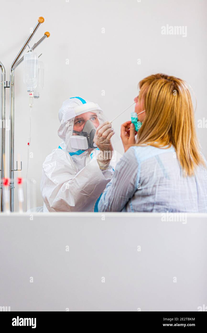 Medical worker performing COVID-19 test, taking nasal swab sample from ...