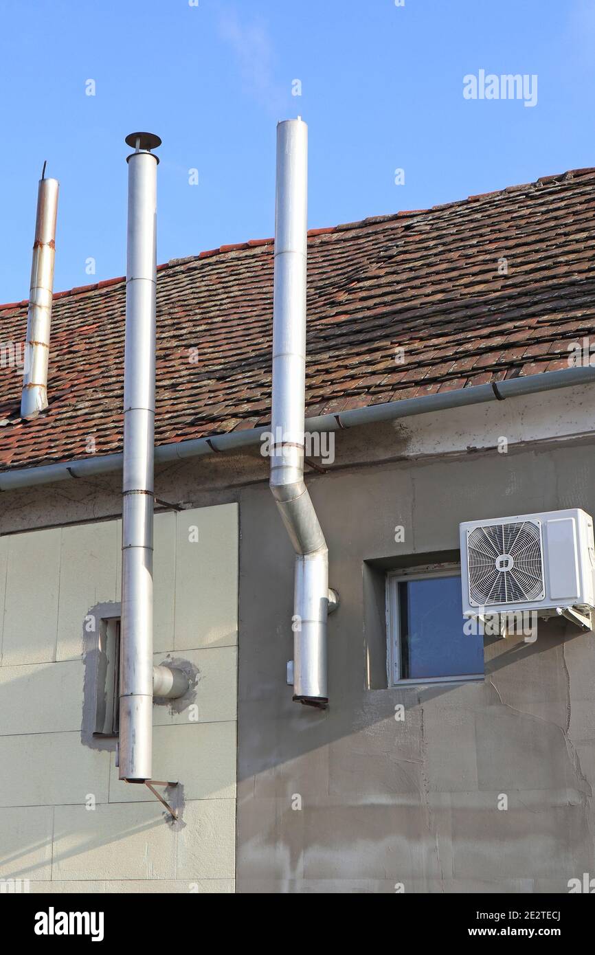 Metal smoke stacks of an old house Stock Photo - Alamy