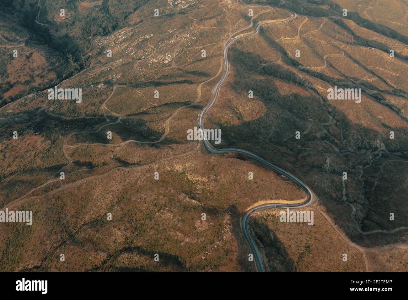 Aerial view of a path leading to an impressive mountain landscape in ...