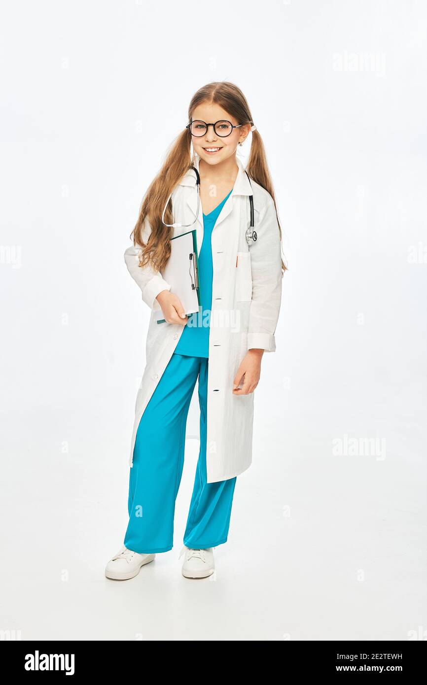 Portrait of a cute girl wearing a doctor coat with phonendoscope ...